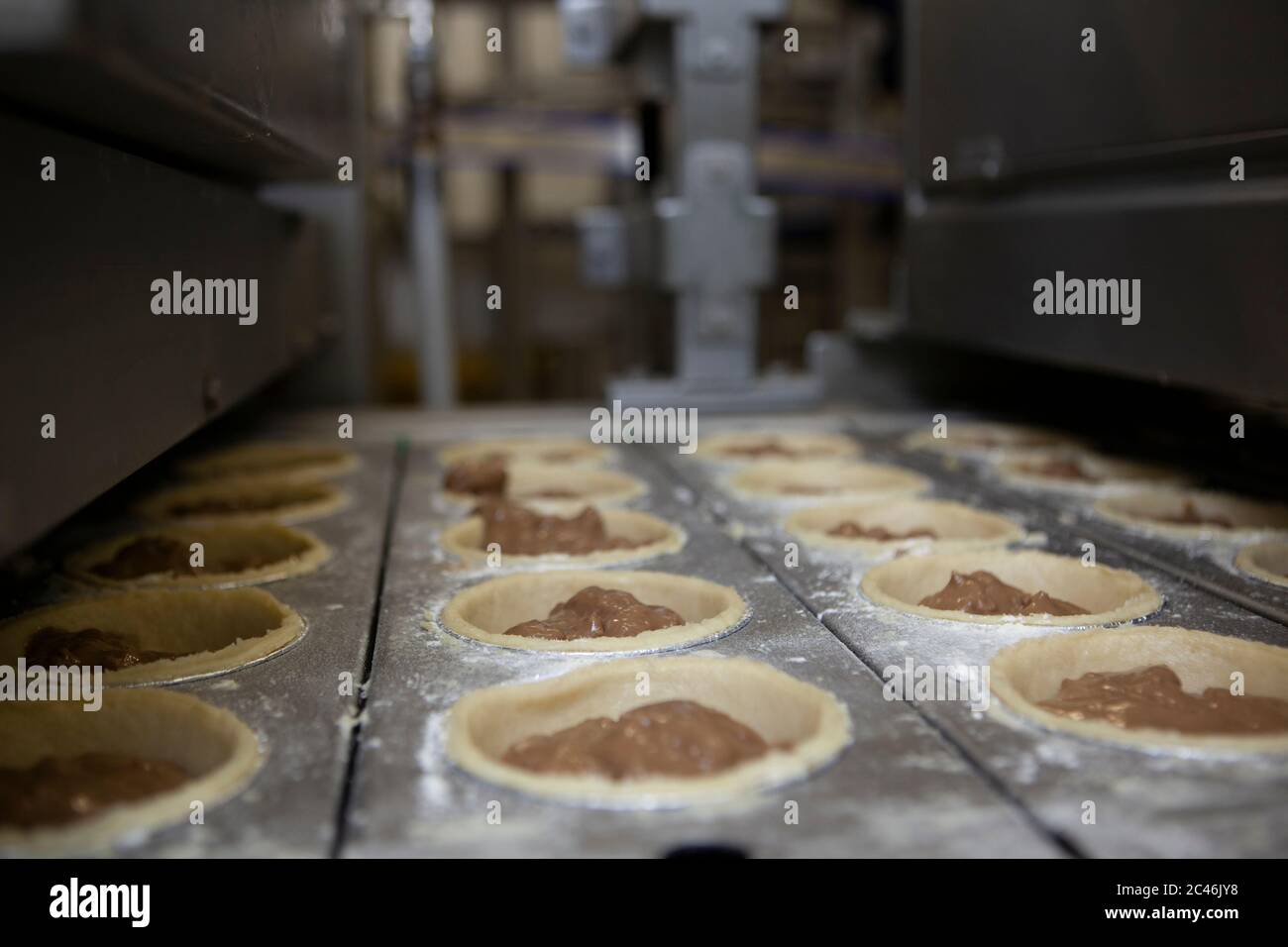 Meat pies come down the production line at a meat processing facility ...