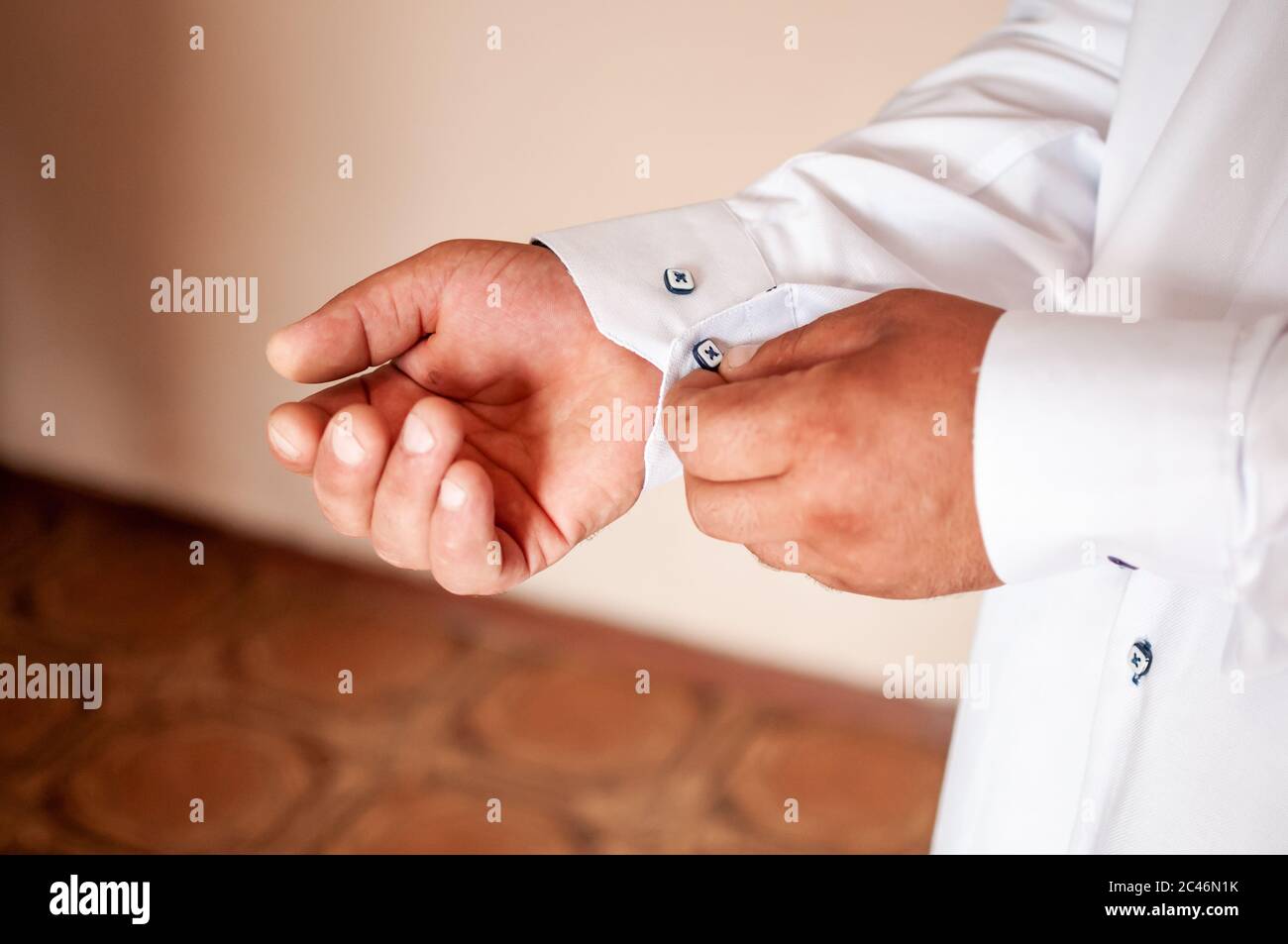 Groom fastens button on sleeve hi-res stock photography and images - Alamy