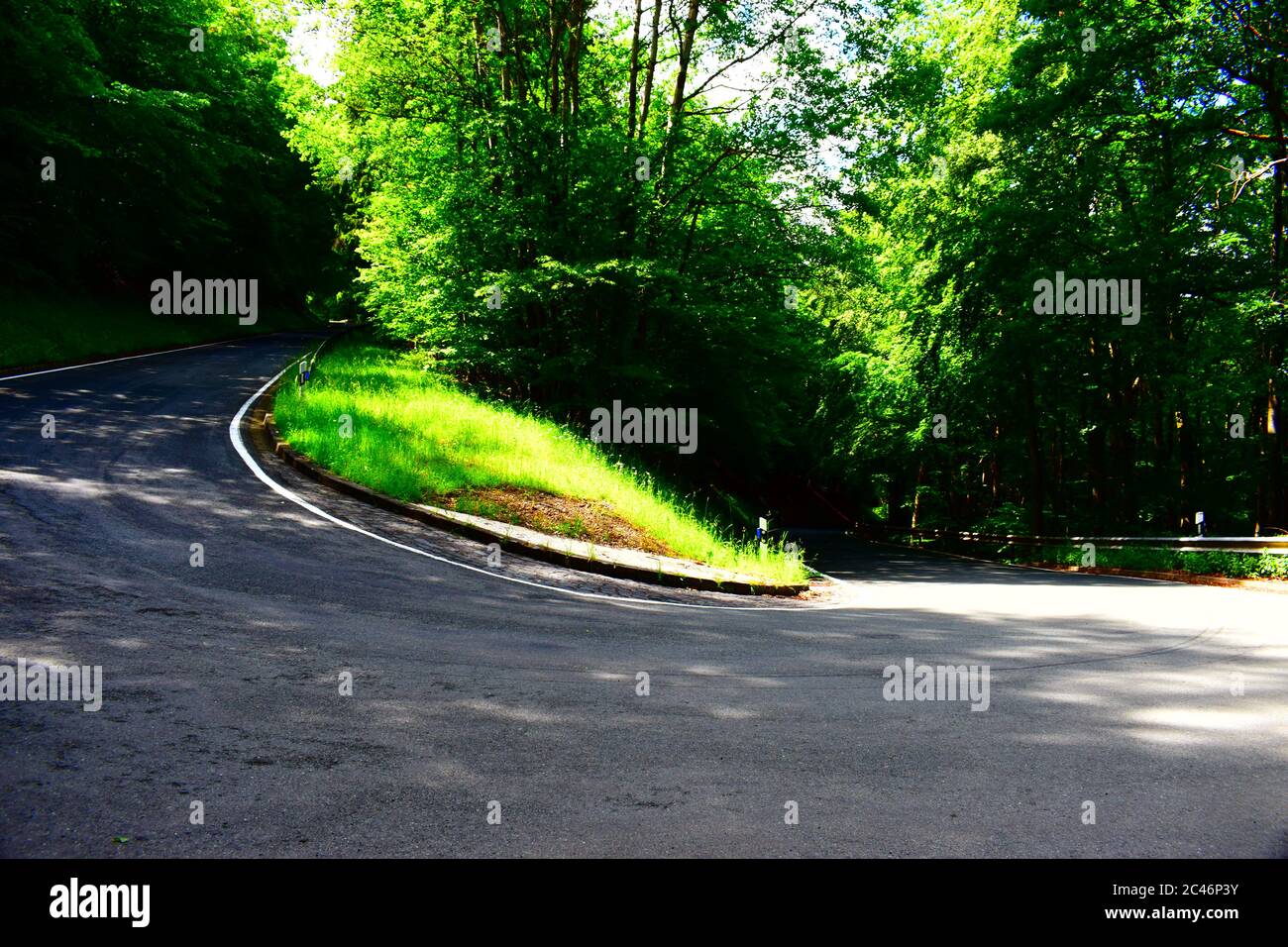steep curve of a narrow road Stock Photo - Alamy