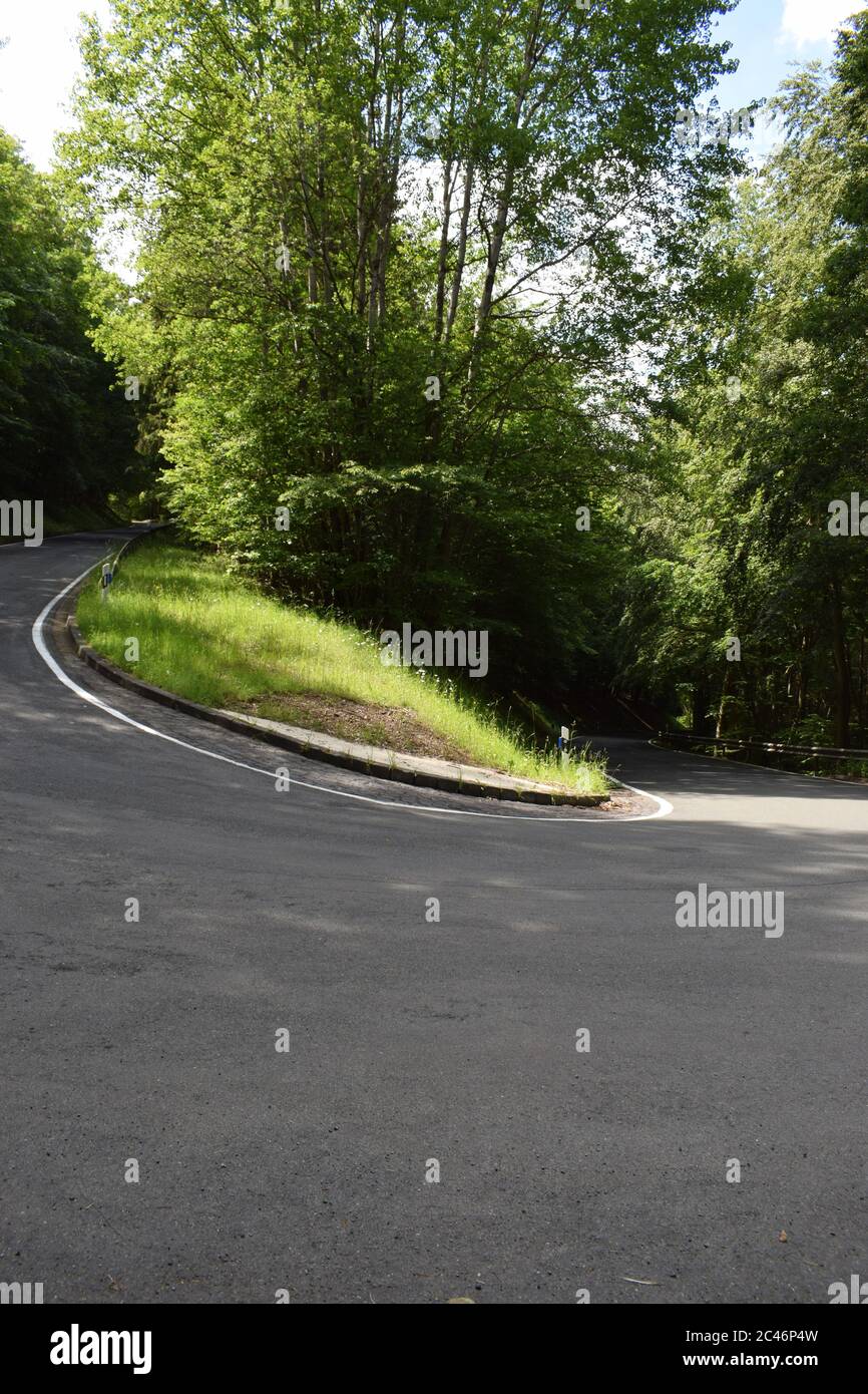 steep curve of a narrow road Stock Photo - Alamy