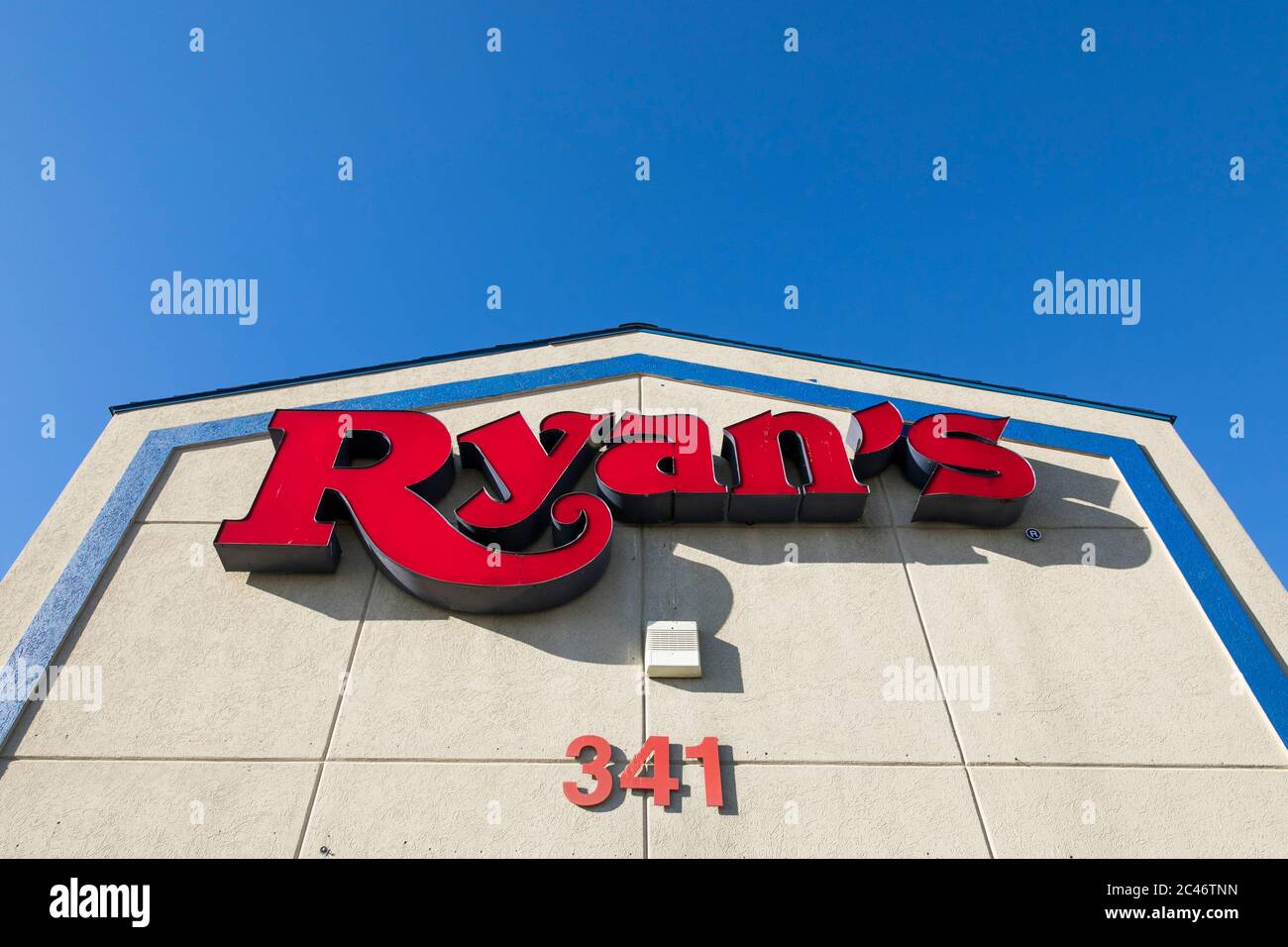 A logo sign outside of a closed and abandoned Ryan's Buffet restaurant ...