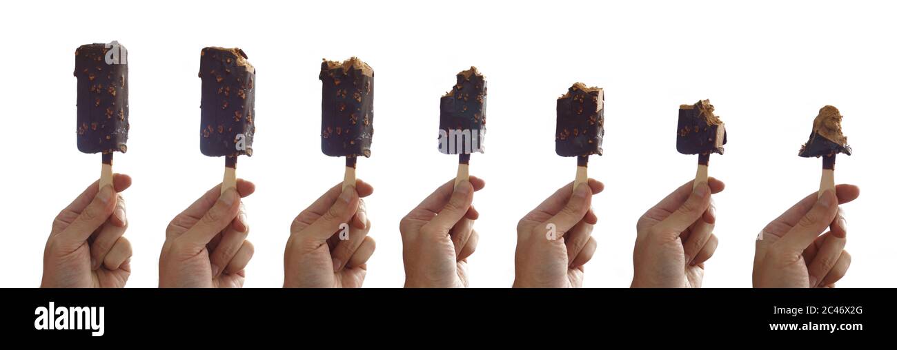 Sequence of an ice cream being eaten step by step. Man's hand holding a ...