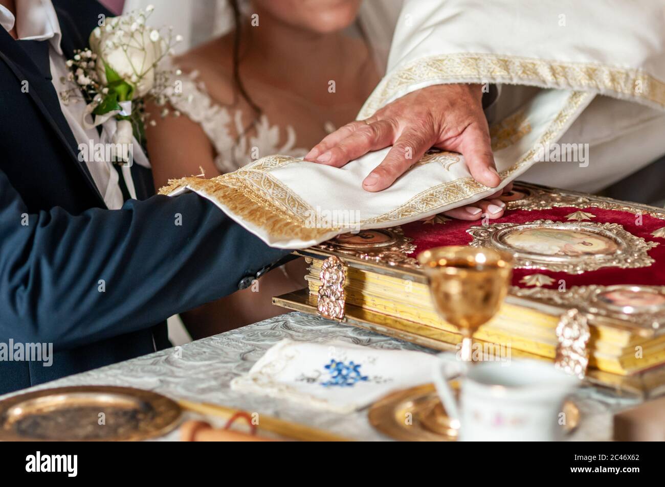 Bride and Groom hands on bible with flowers Stock Photo - Alamy