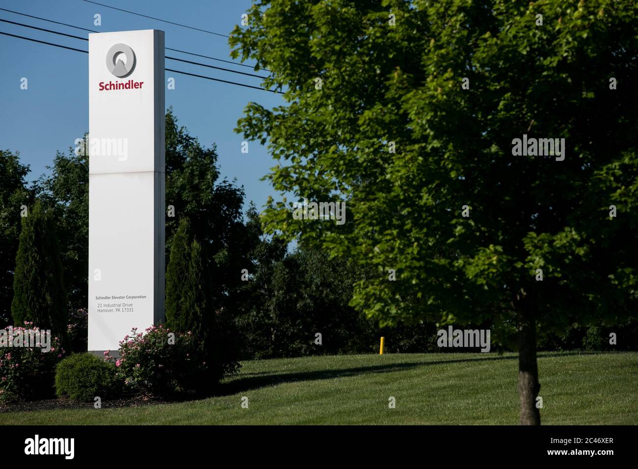 A logo sign outside of a facility occupied by Schindler Elevator ...