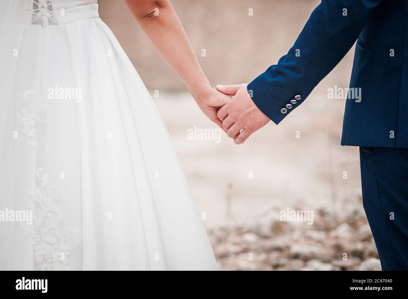 Couple of married holding hands Stock Photo - Alamy
