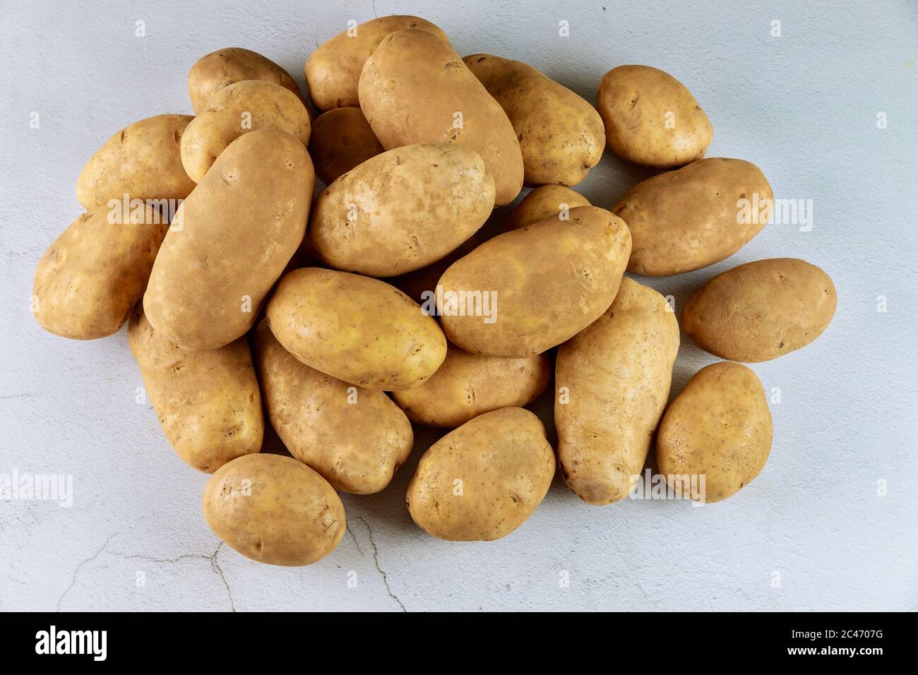 Unpeeled raw organic potatoes on white background Stock Photo - Alamy