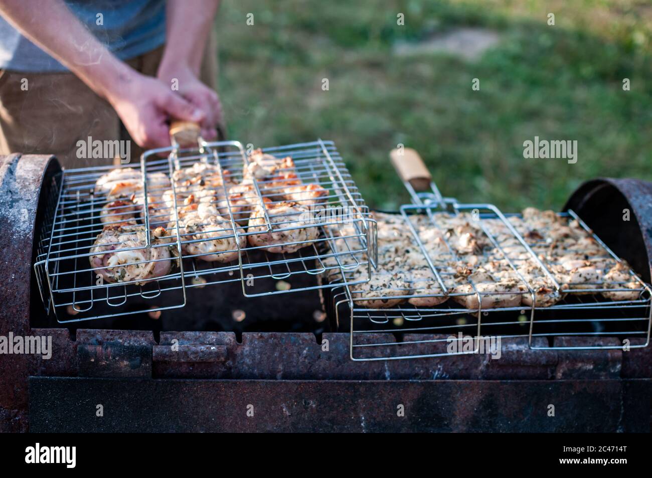 cooking raw meat in a grid on the barbeque grill Stock Photo - Alamy