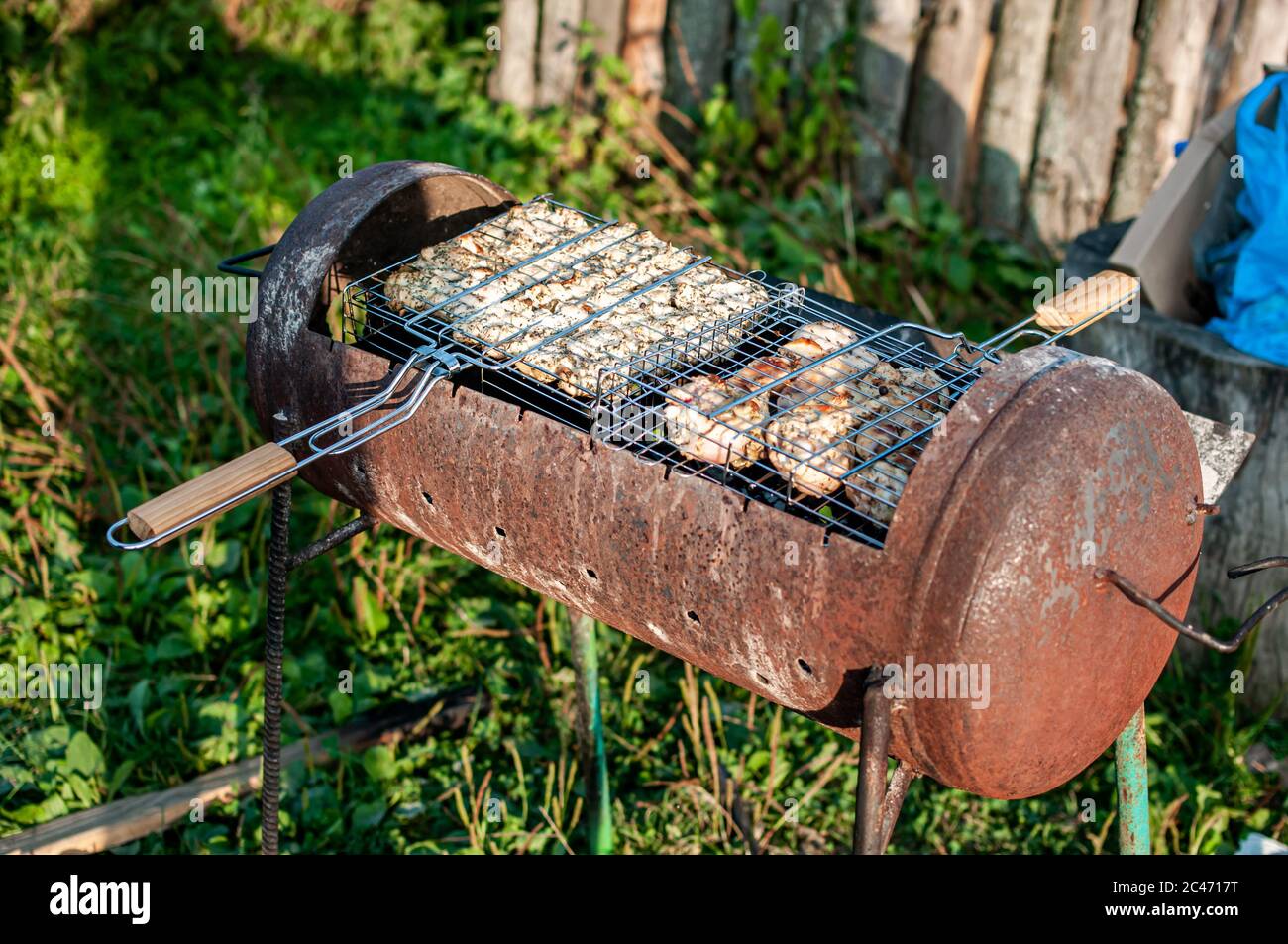 cooking raw meat in a grid on the barbeque grill Stock Photo - Alamy