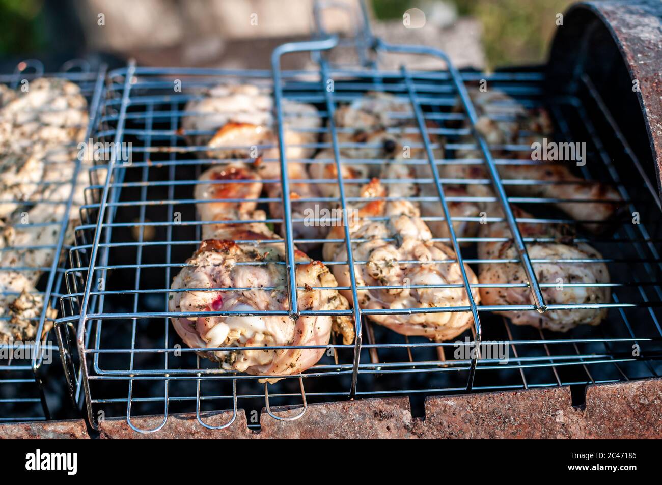 cooking raw meat in a grid on the barbeque grill Stock Photo - Alamy