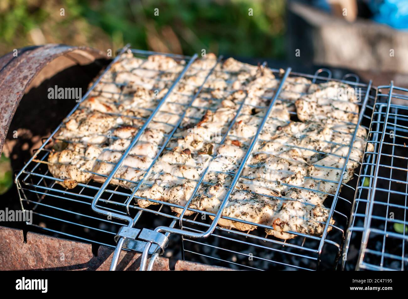 cooking raw meat in a grid on the barbeque grill Stock Photo - Alamy