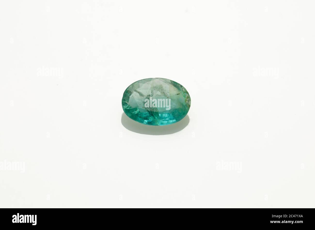 Natural green emerald oval shape on the white background Stock Photo ...