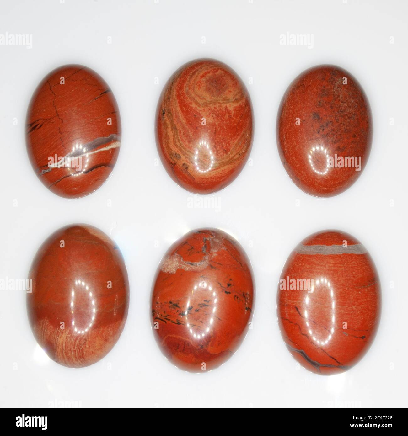 Natural red polished jasper on the white background Stock Photo - Alamy