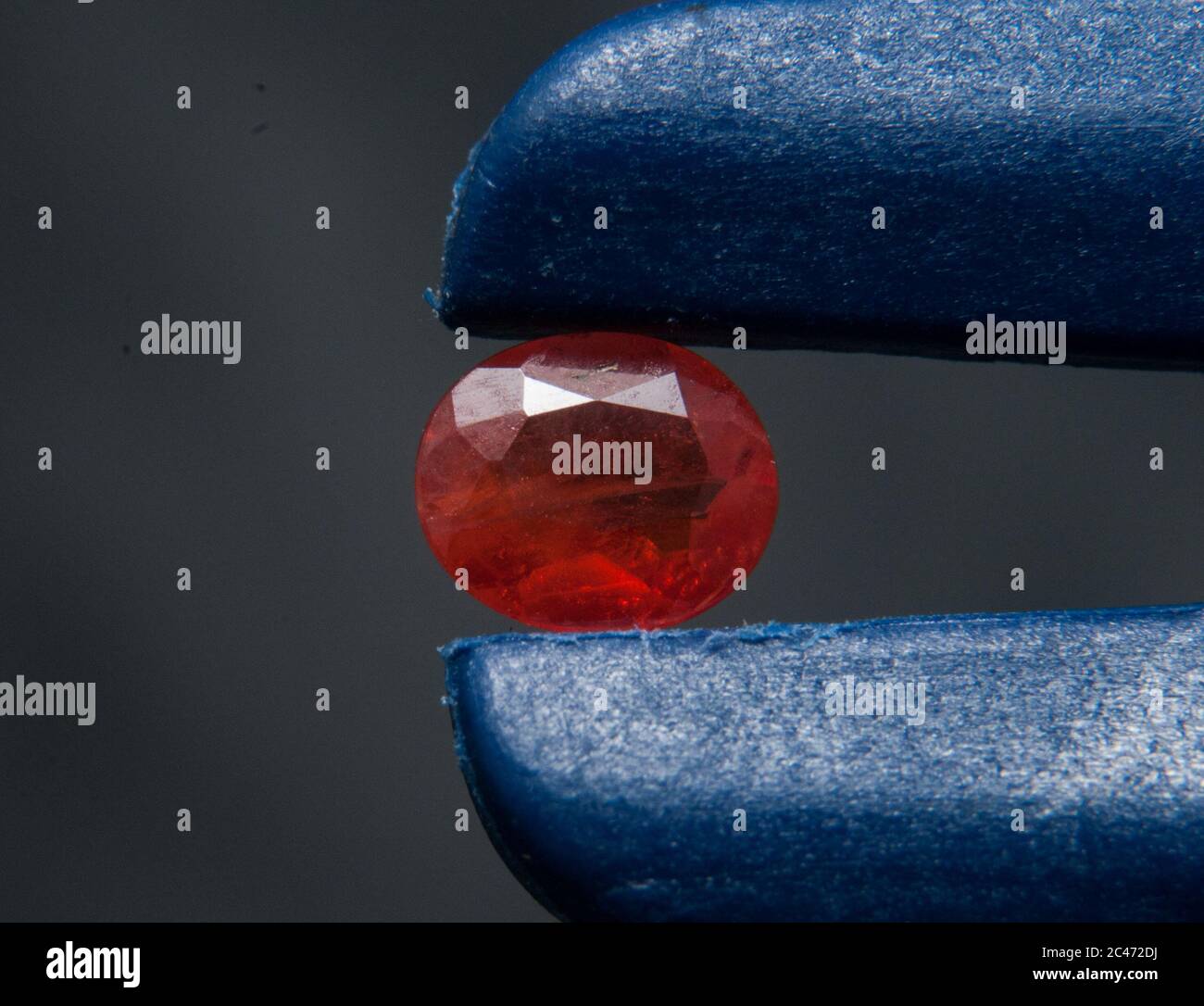 Natural oval red ruby on the black background Stock Photo - Alamy