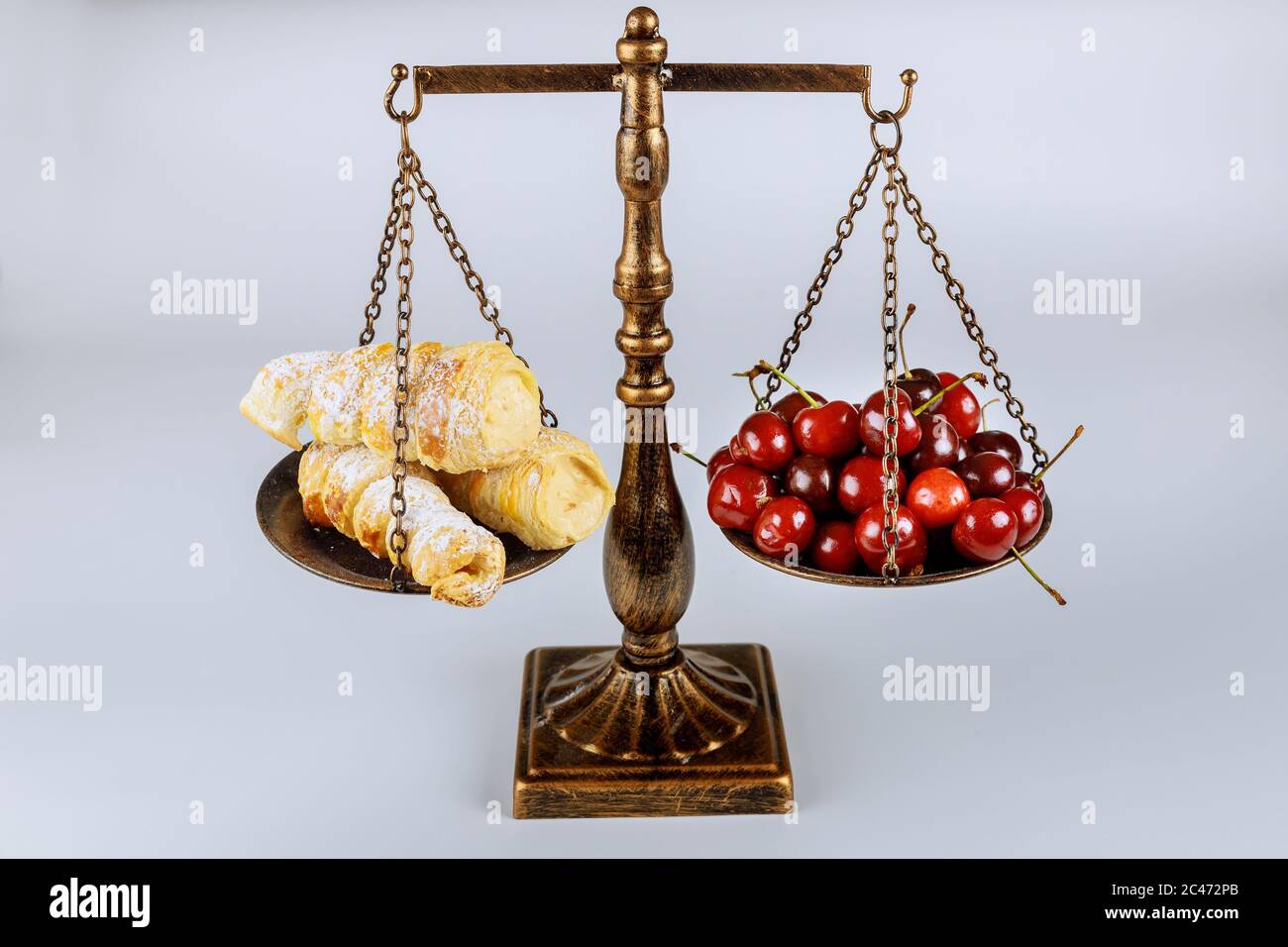 Scale with healthy food and junk food on white isolated background ...