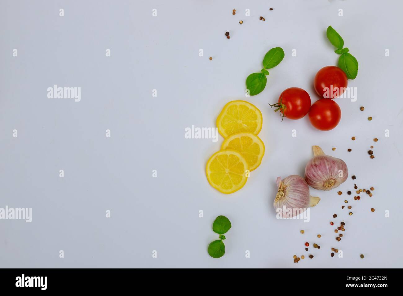 Organic spices with lemon and tomato on white background Stock Photo ...