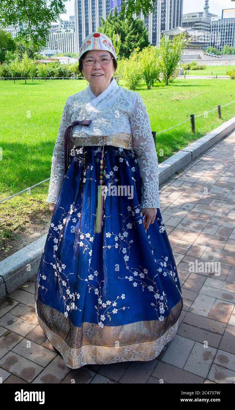 A local Korean woman in front of the royal palace in Seoul wearing a ...