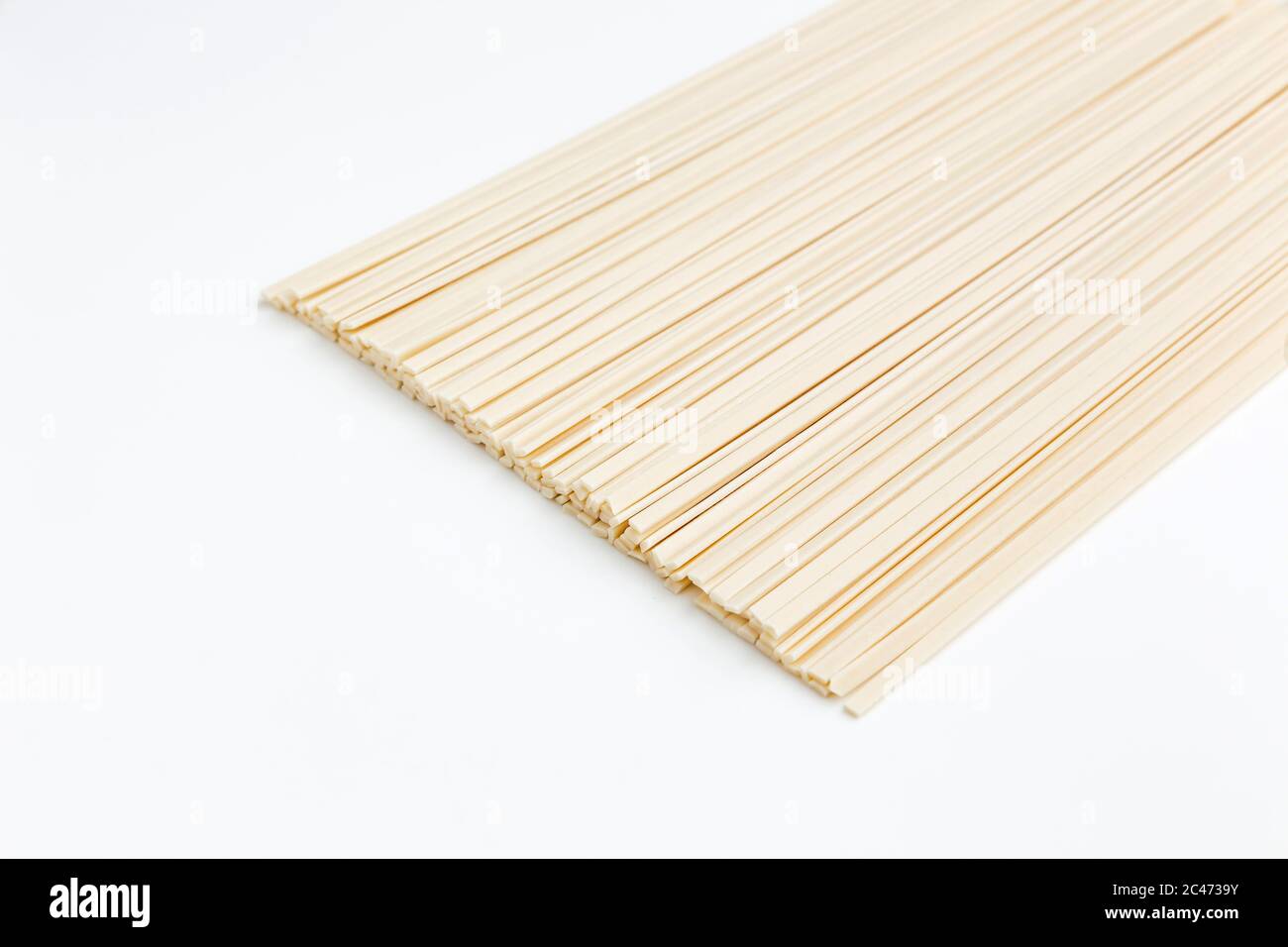 Raw udon noodles on white, horizontal photo Stock Photo - Alamy