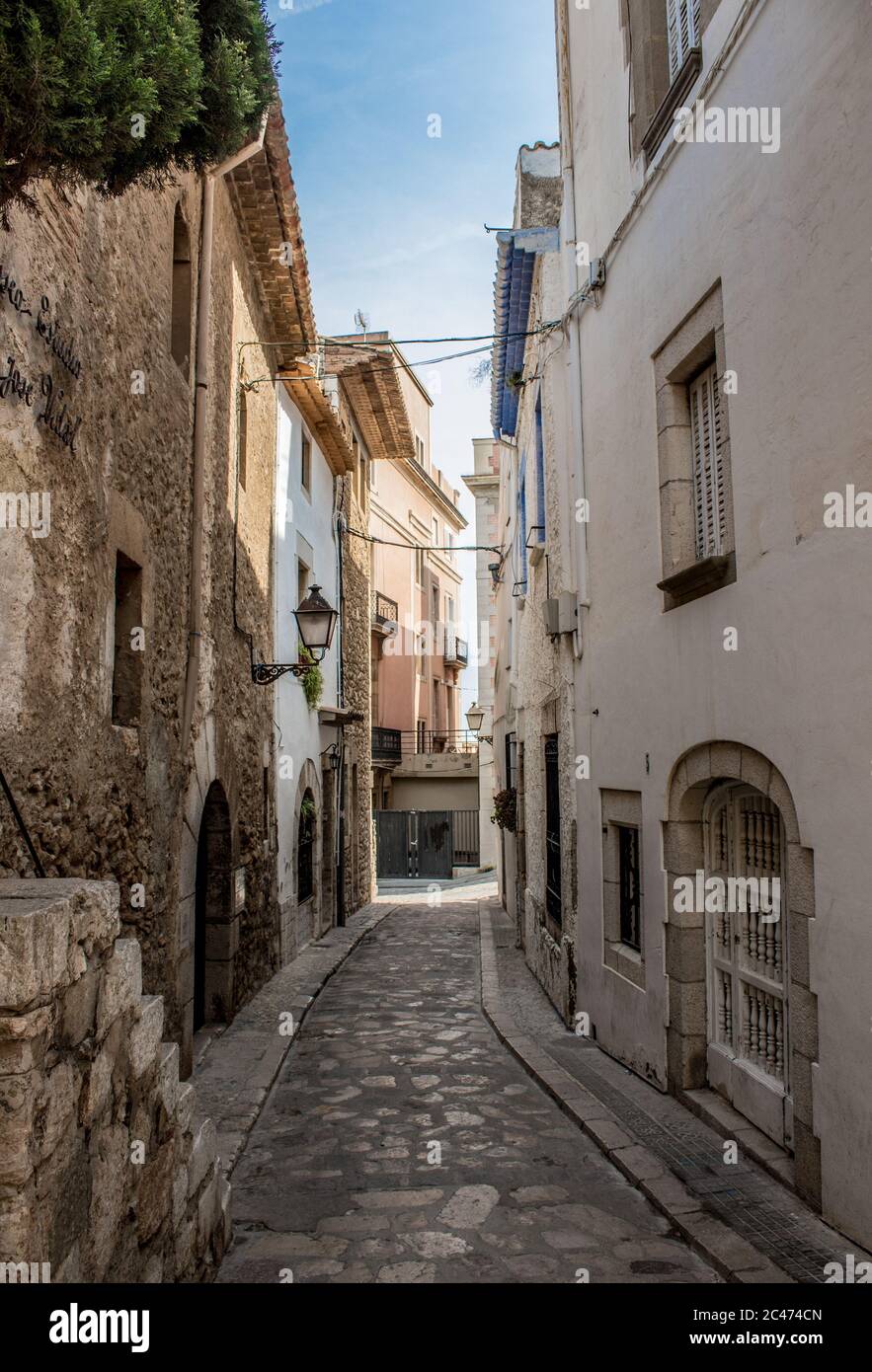 Vertical shot of a narrow street between stone houses Stock Photo - Alamy