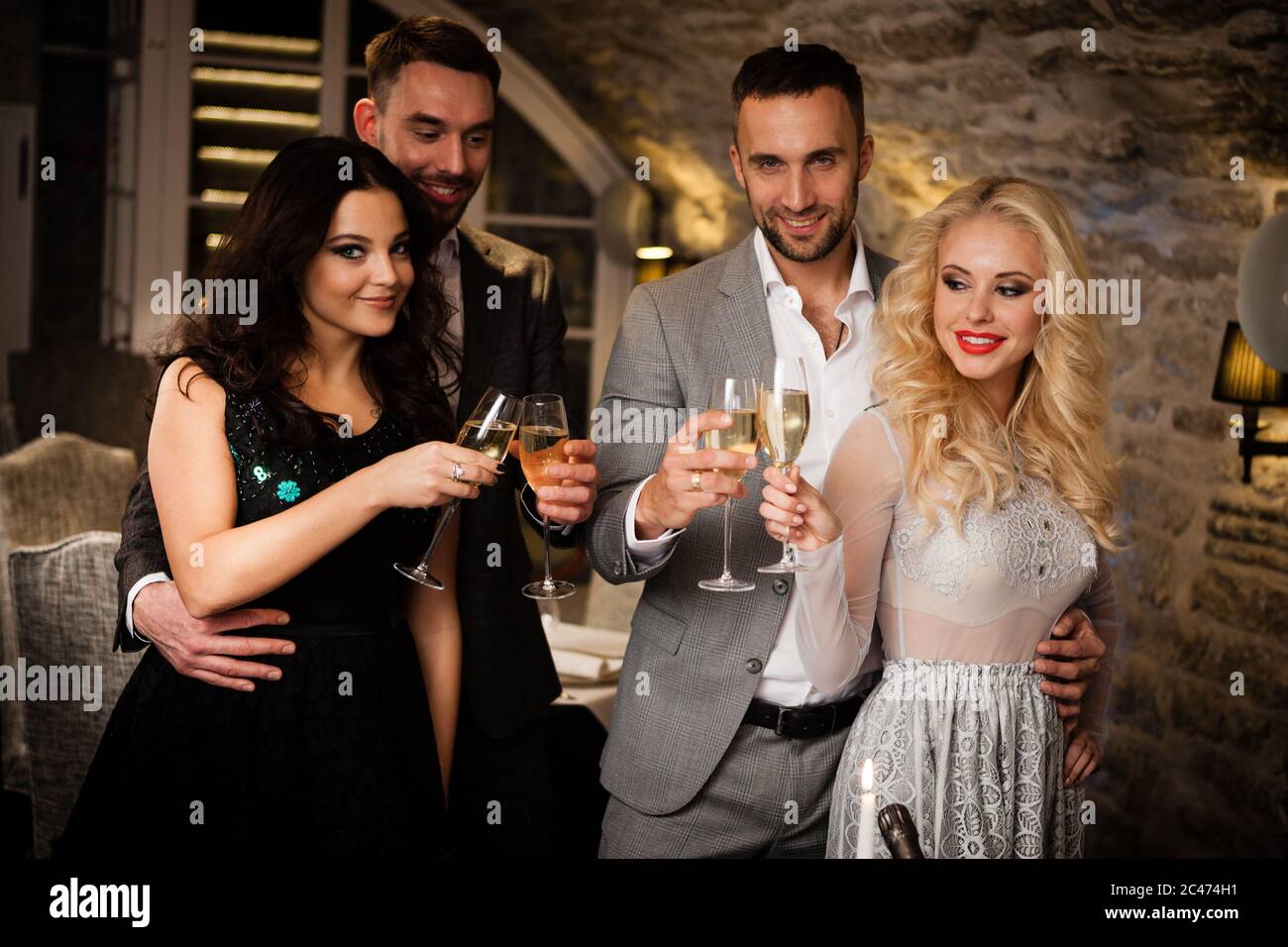Party, holiday with friends concept. Four people with champagne glasses ...