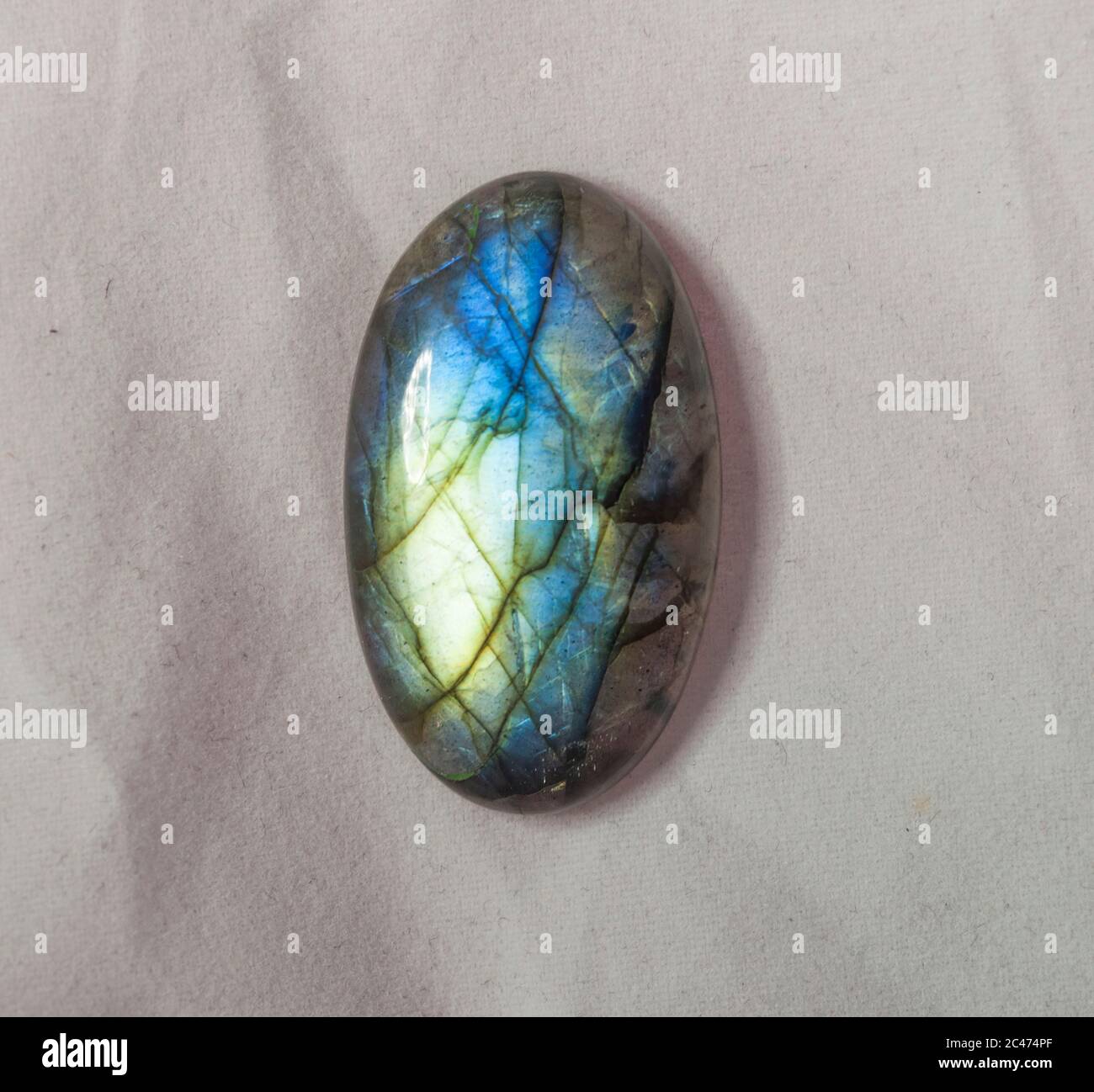 Natural oval labradorite gem on the white background Stock Photo - Alamy