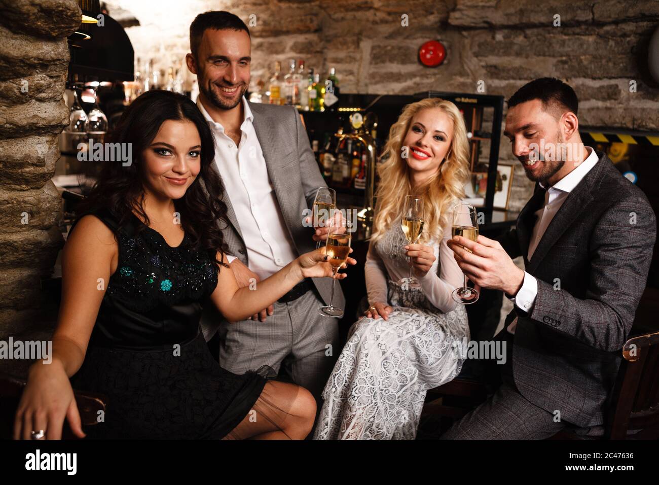 Party, holiday with friends concept. Four people with champagne glasses ...