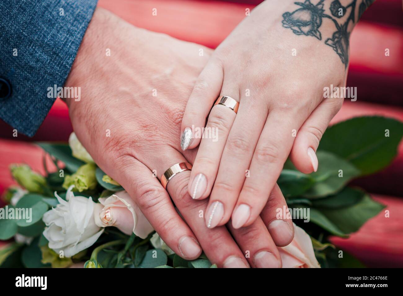 Pair of hands with gold wedding rings Stock Photo - Alamy