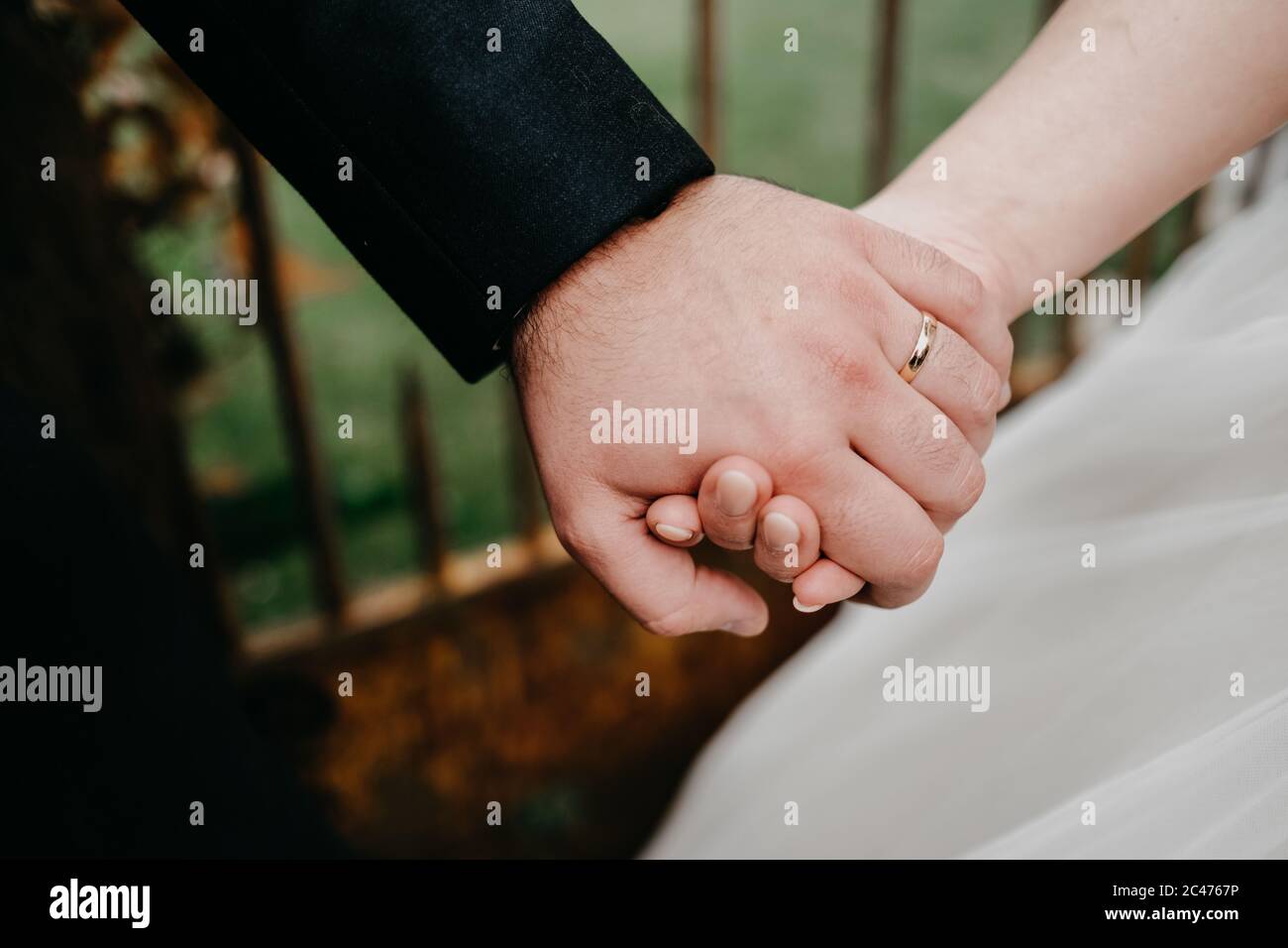 Close up shot of a romantic couple holding hands Stock Photo - Alamy