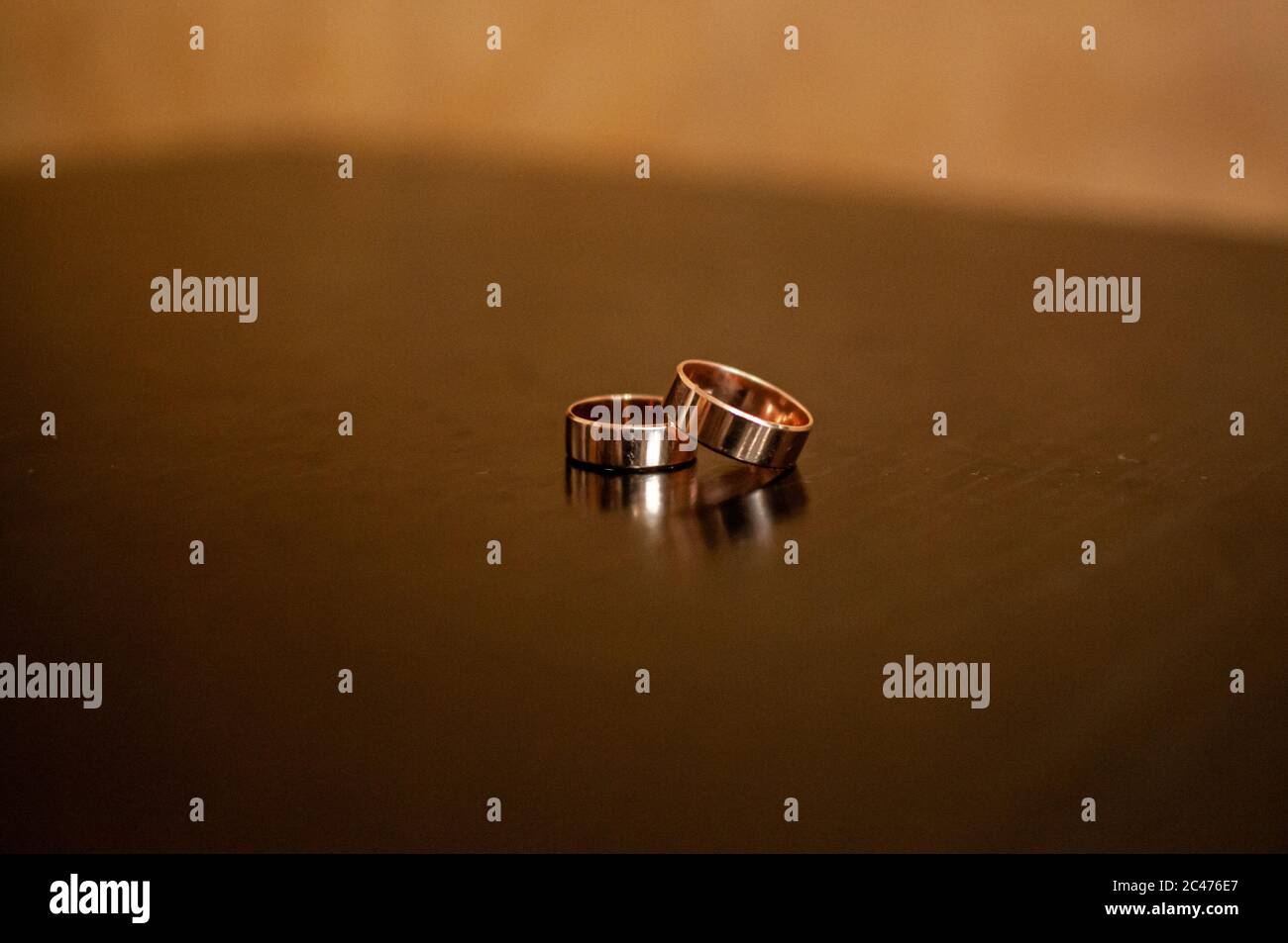 Pair of gold wedding rings on the table Stock Photo - Alamy