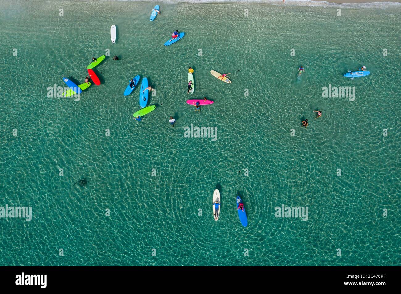 Jupiter, Florida, USA. 24th June, 2020. Kids float on their surfboards ...