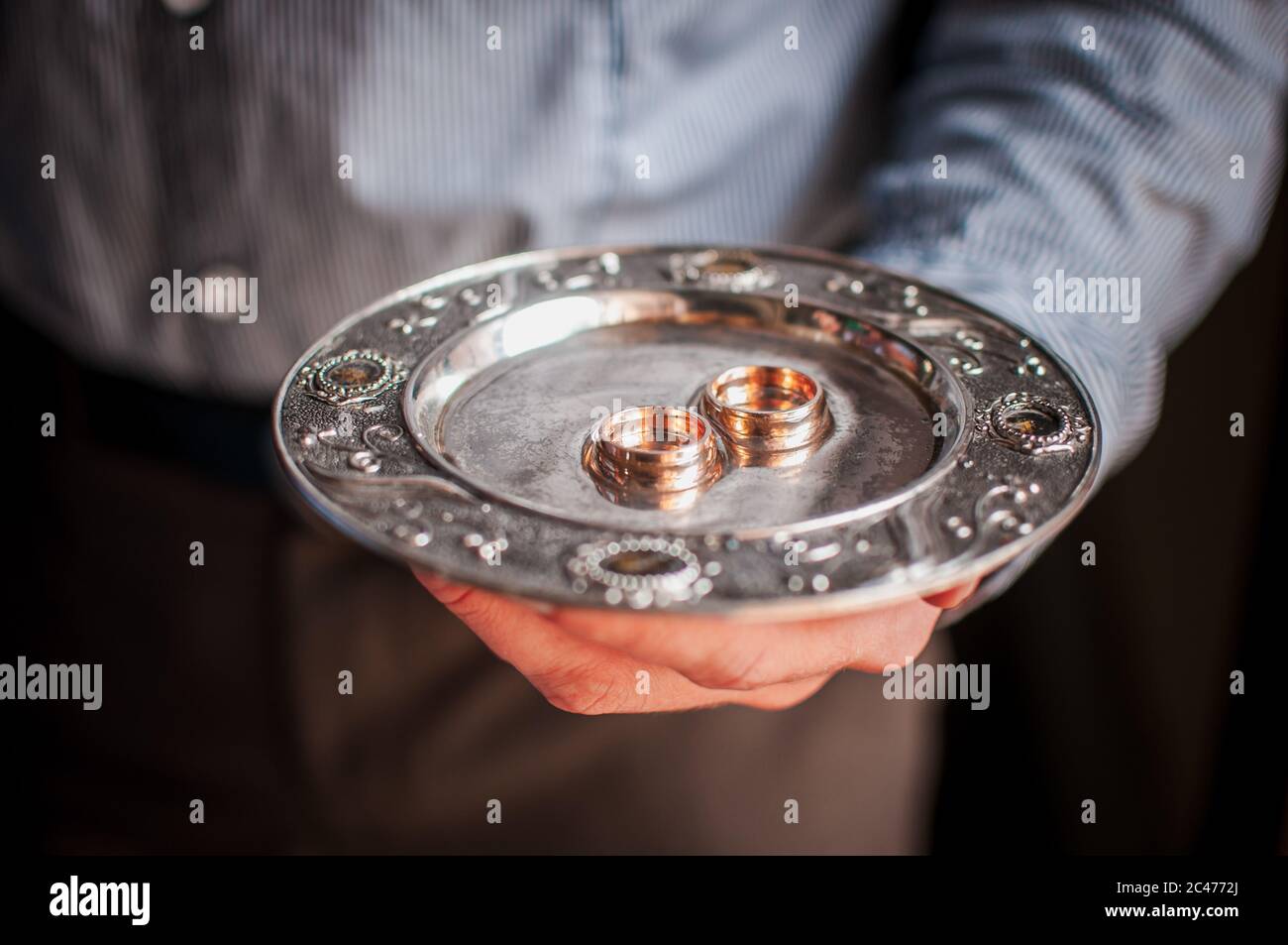 Gold wedding rings on the gold plate Stock Photo - Alamy