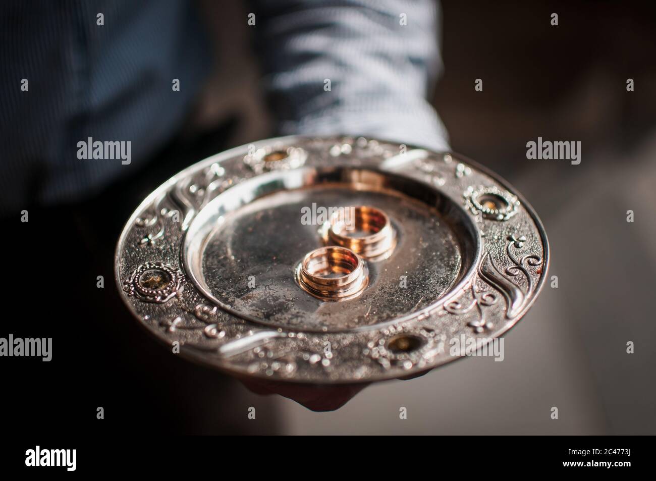 Gold wedding rings on the gold plate Stock Photo - Alamy