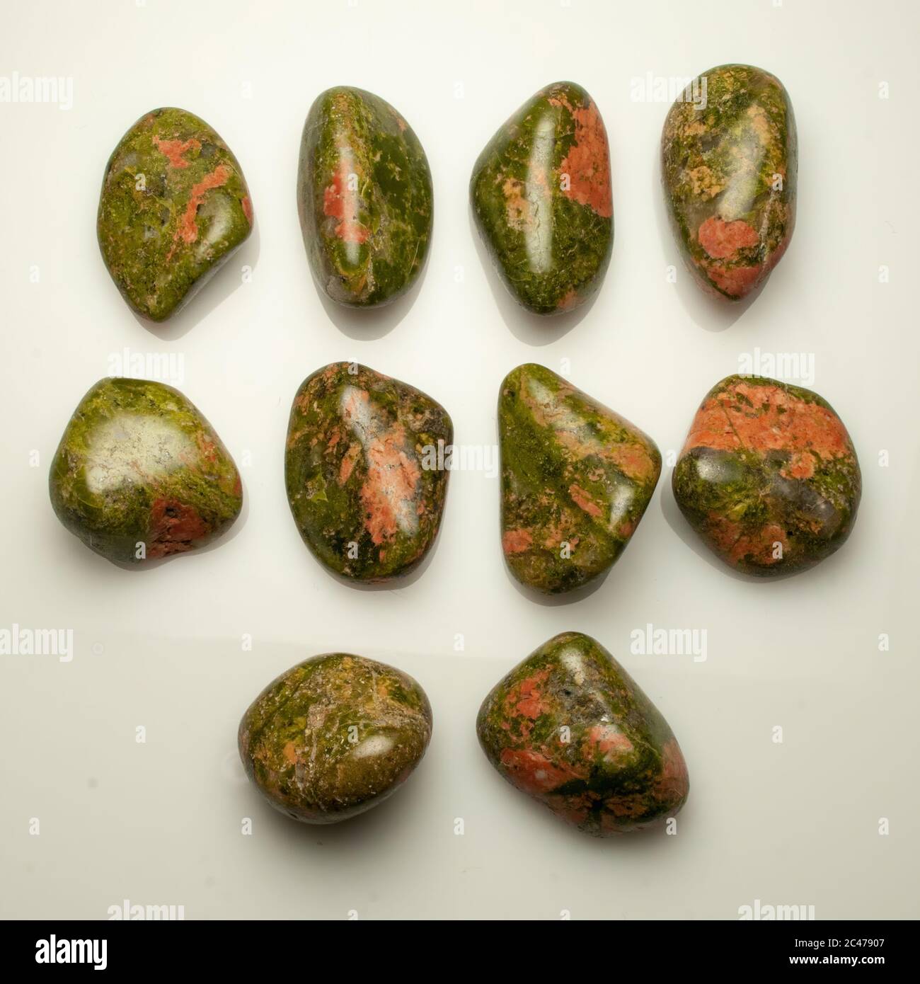 Natural tumbled unakite on the white background Stock Photo - Alamy