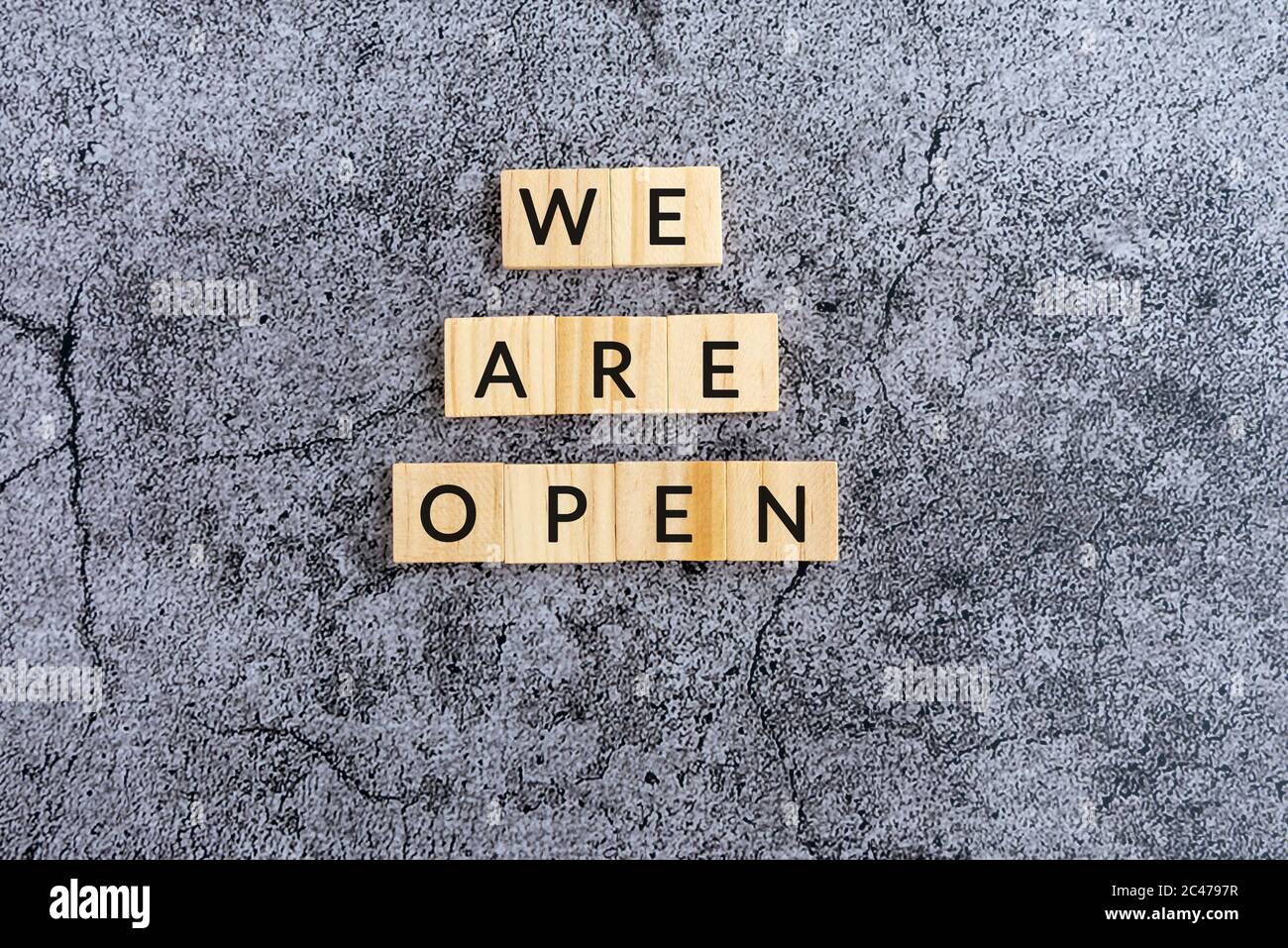 We are open text on wooden block textures background Stock Photo - Alamy