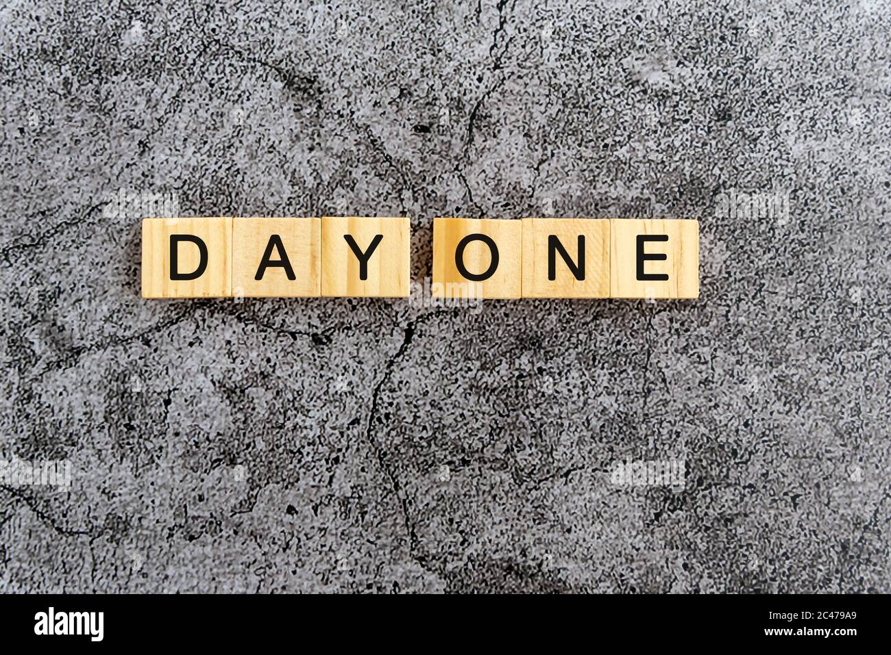 Day one text on wooden block textures background Stock Photo - Alamy