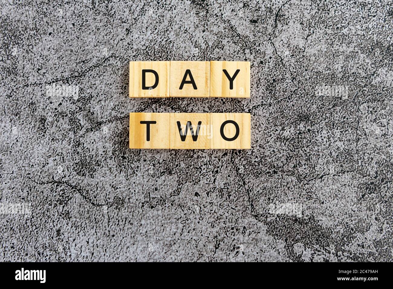 Day Two text on wooden block textures background Stock Photo - Alamy