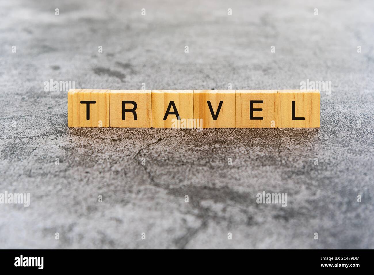 Travel text on wooden block textures background Stock Photo - Alamy
