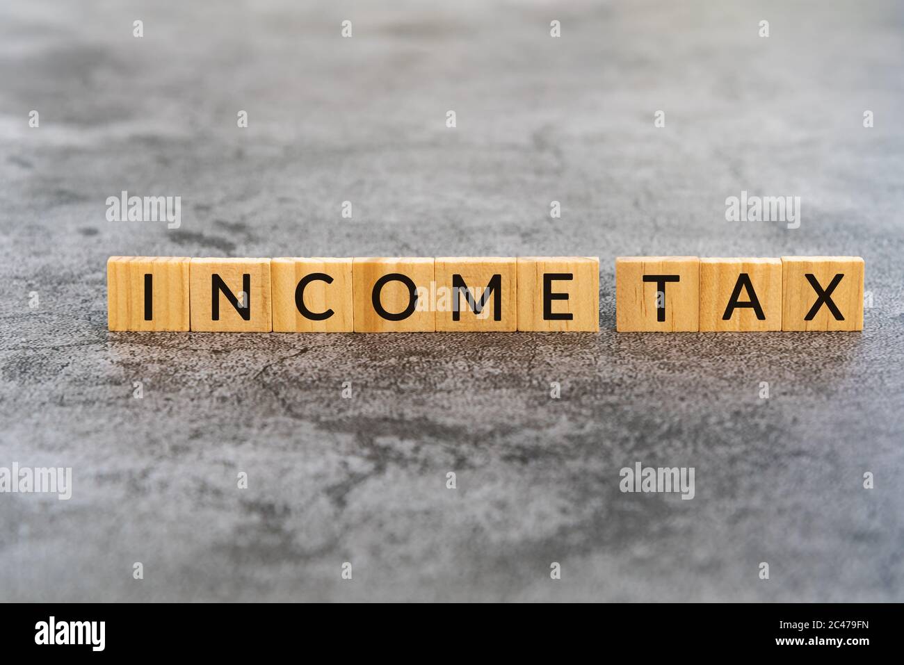 Income tax text on wooden block textures background Stock Photo - Alamy