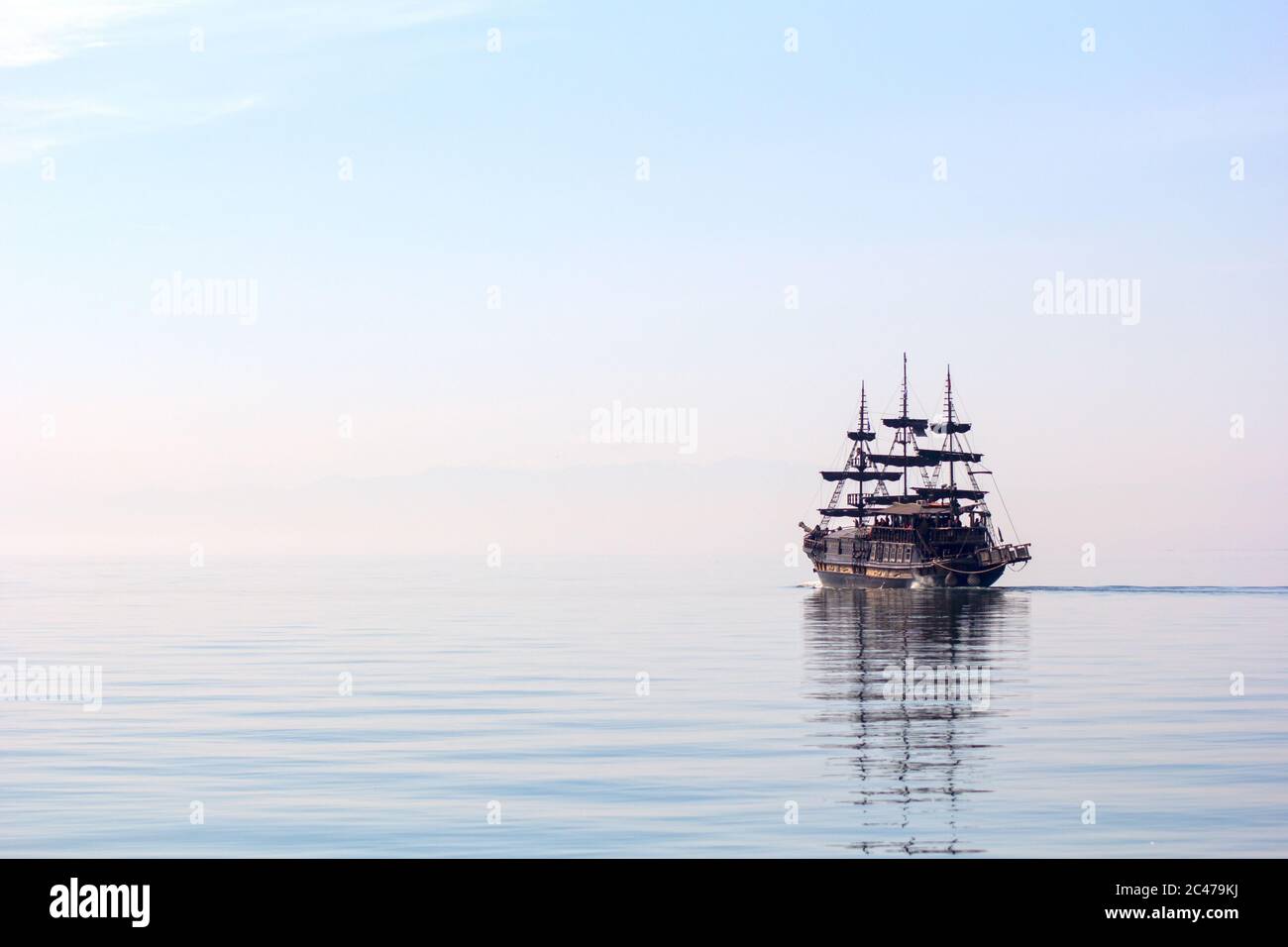 Horizontal shot of a tall ship sailing on beautiful clear water during ...