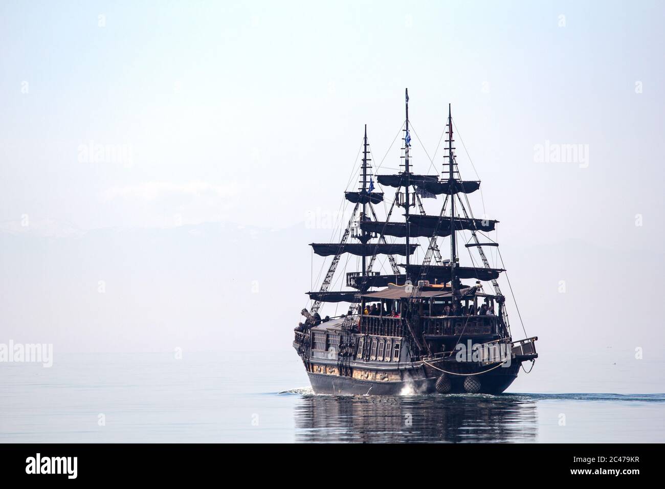Horizontal shot of a tall ship sailing on beautiful clear water during ...