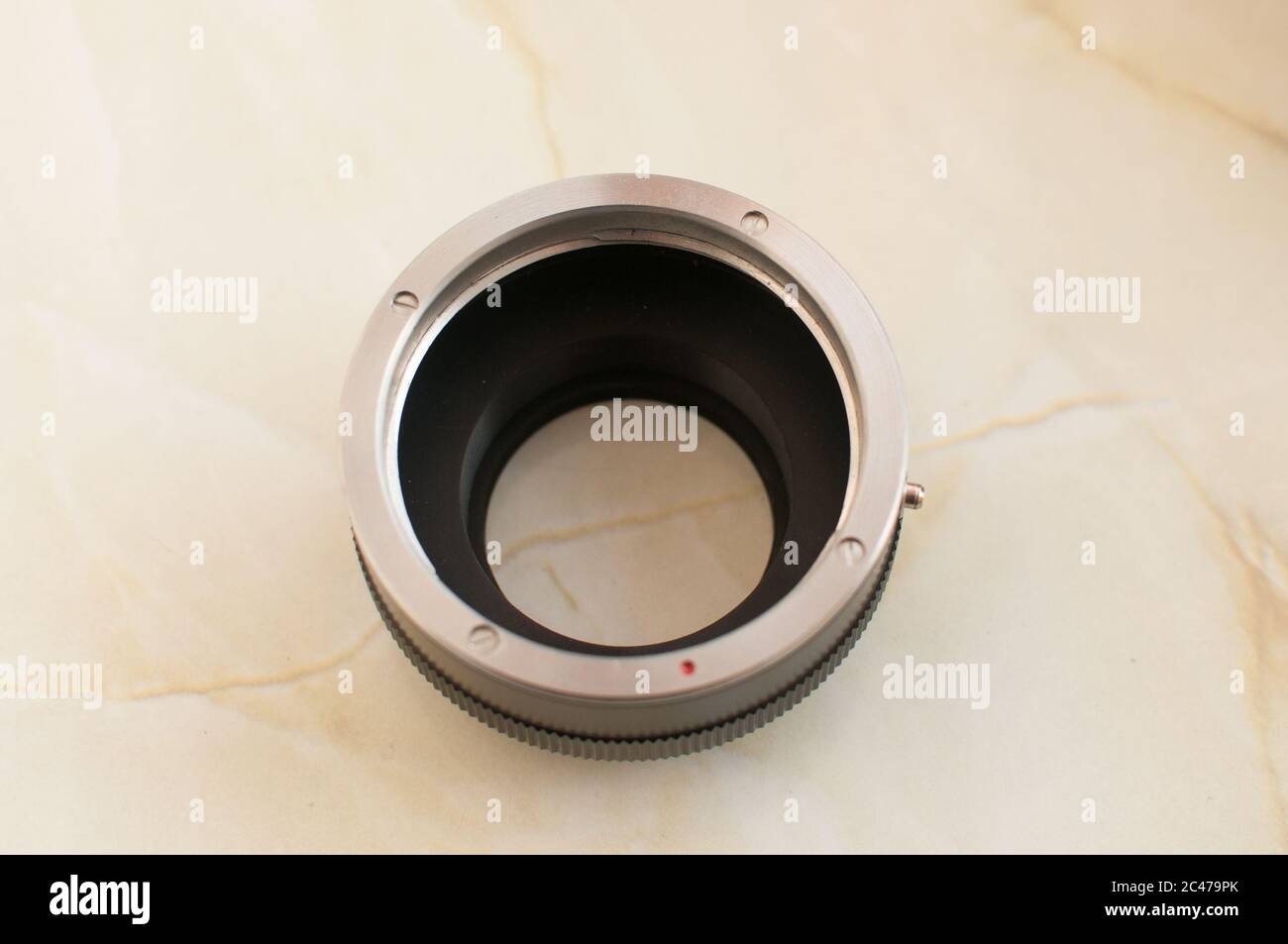 Metal lens adaptor for camera on the surface Stock Photo - Alamy