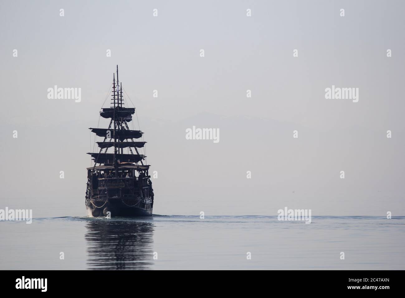 Horizontal shot of a tall ship sailing on beautiful clear water during ...