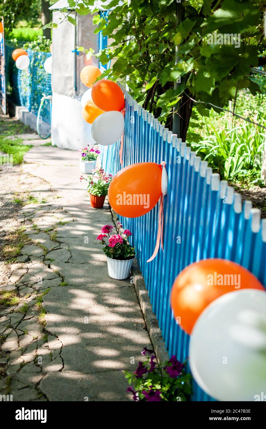 Colorfull air balloons on the blue metal fence Stock Photo - Alamy