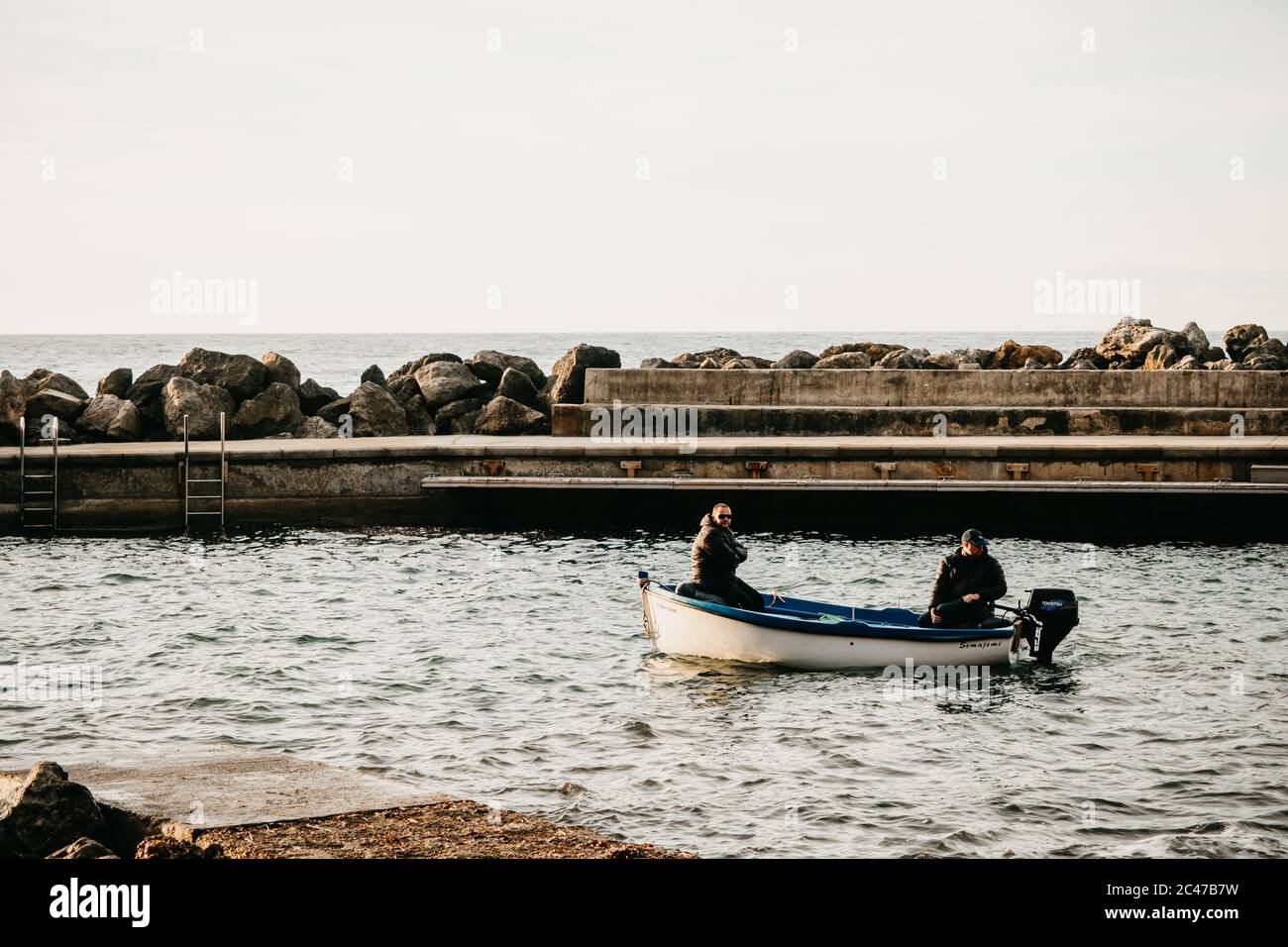 Beautiful shot two men riding a boat in the sea Stock Photo - Alamy