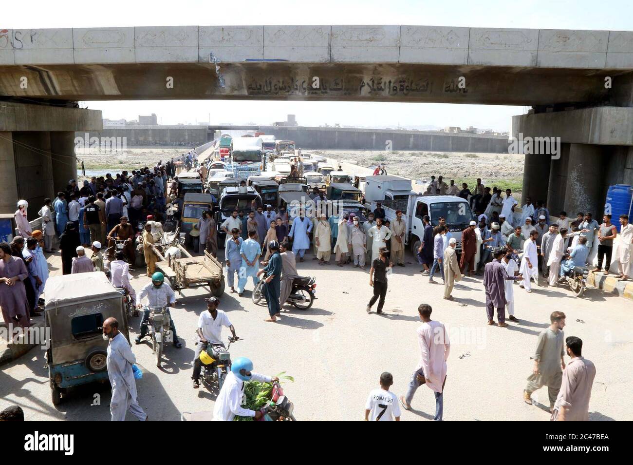 Residents of Lyari Meera Naka block road as they are holding protest ...