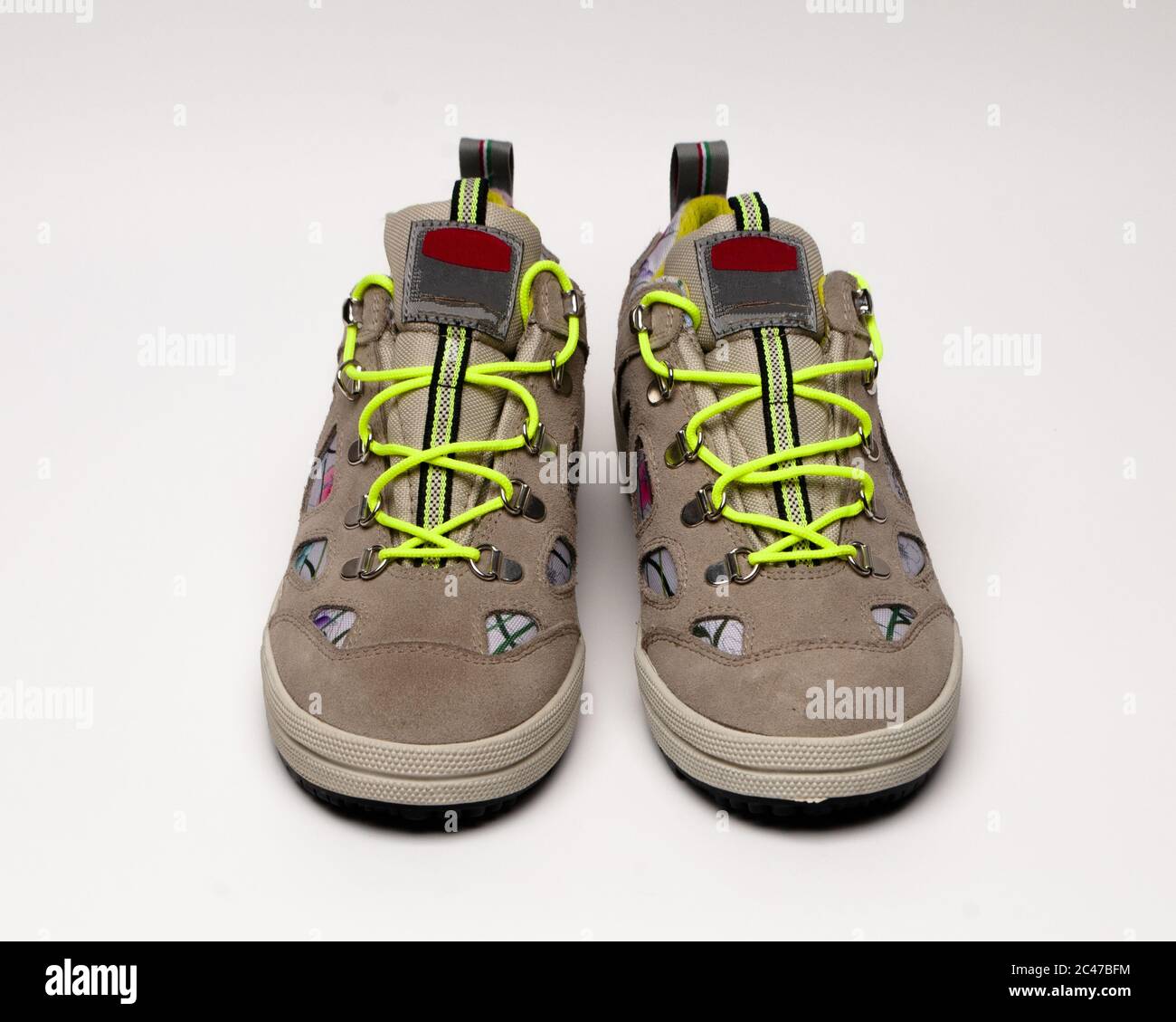 Pair of woman tracking shoes on the white background Stock Photo - Alamy