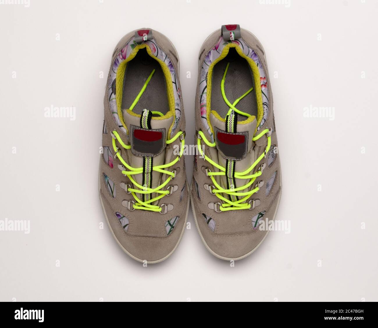 Pair of woman tracking shoes on the white background Stock Photo - Alamy