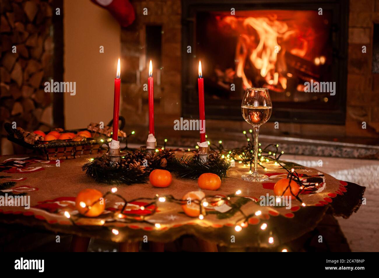 Three red fire candles and glass with chamapgne Stock Photo - Alamy