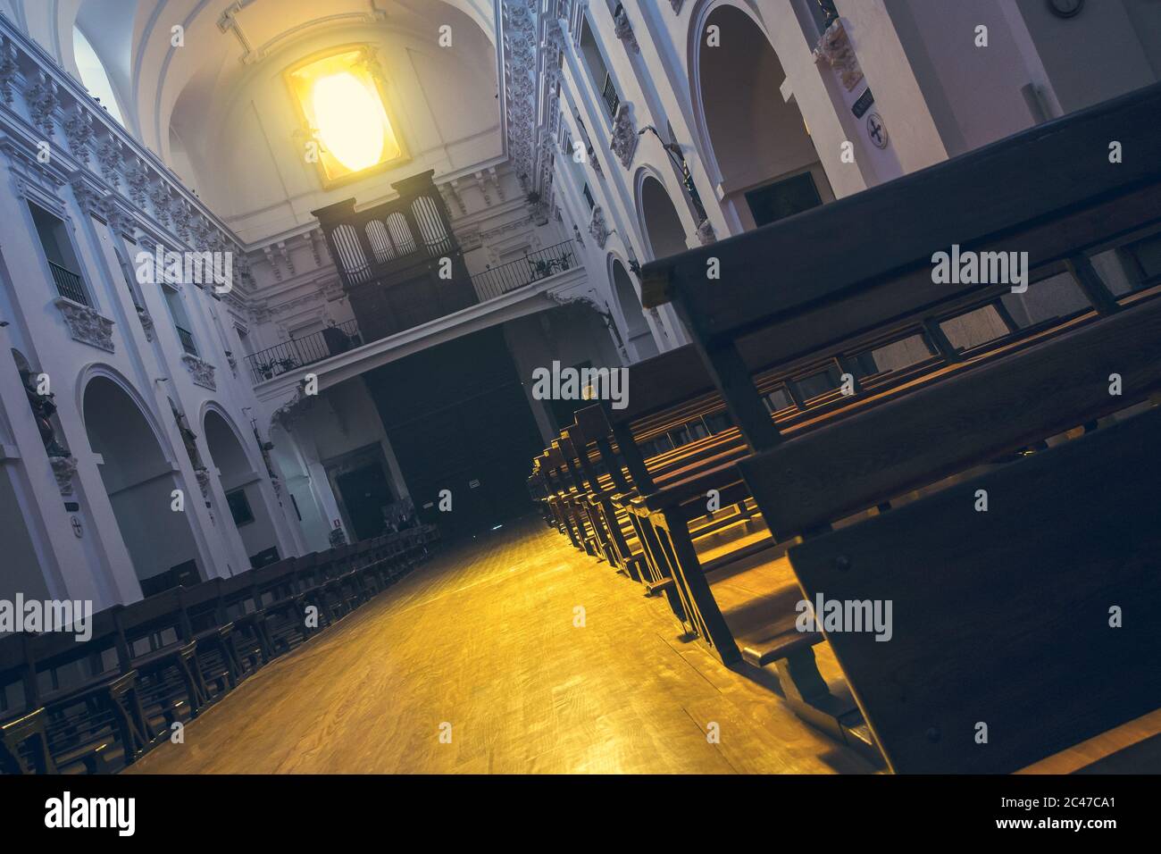Inside of a church with empty wooden benches Stock Photo - Alamy