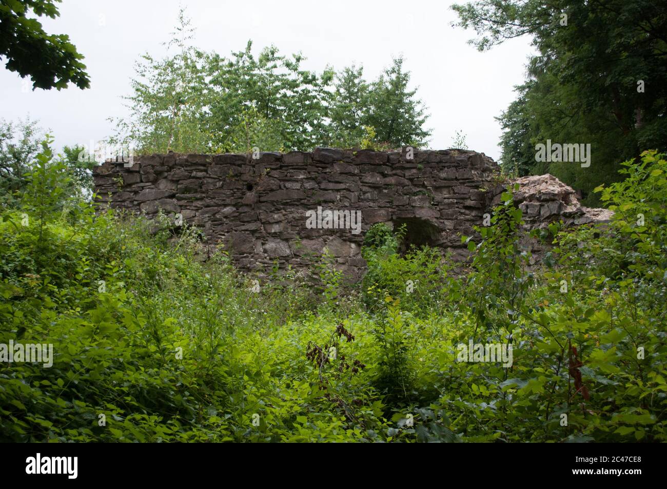 Stone wall of the ruined abandoned castle Stock Photo - Alamy