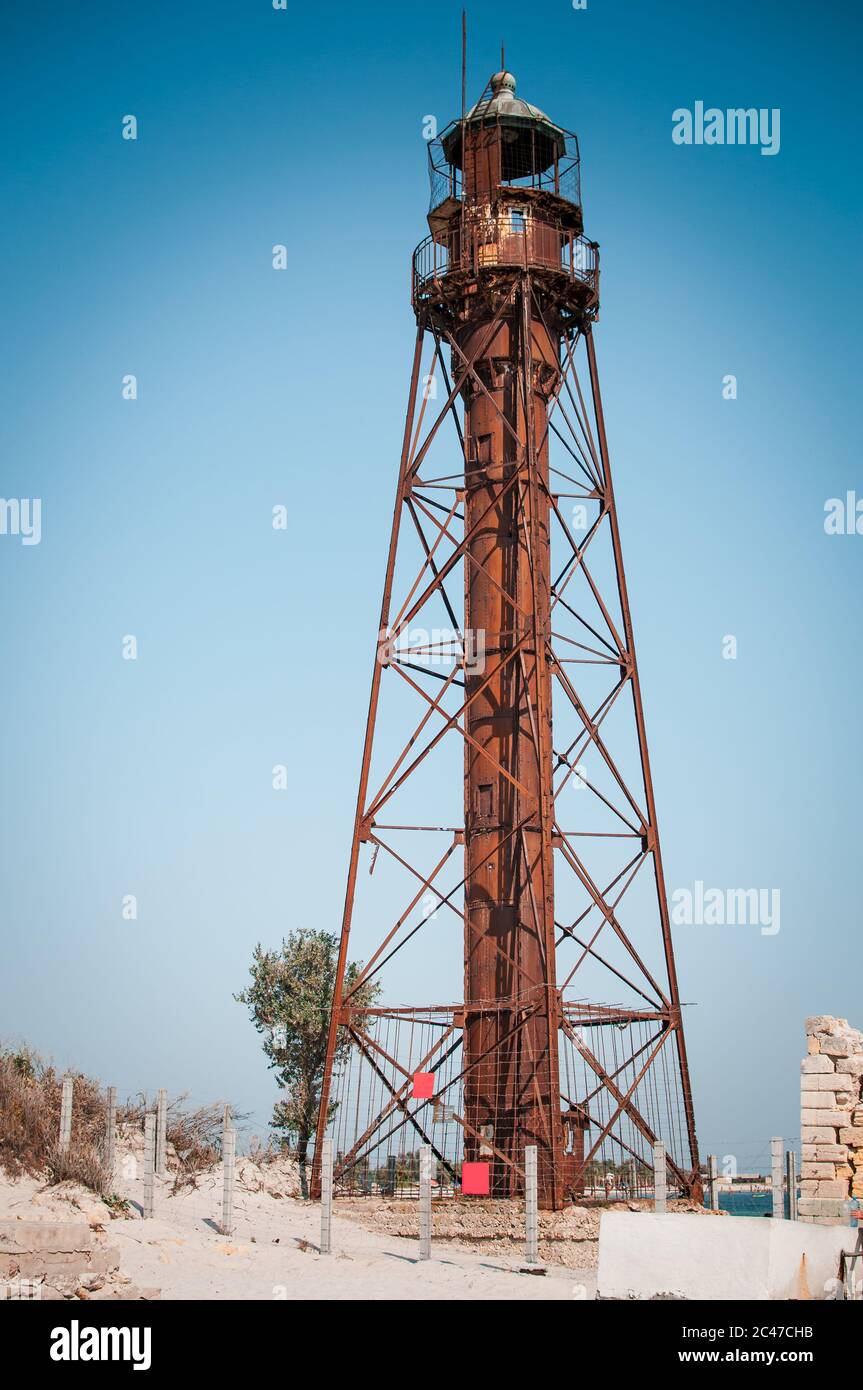 Old abandoned steel rusty lighthouse on the beach on the Dzharylgach ...